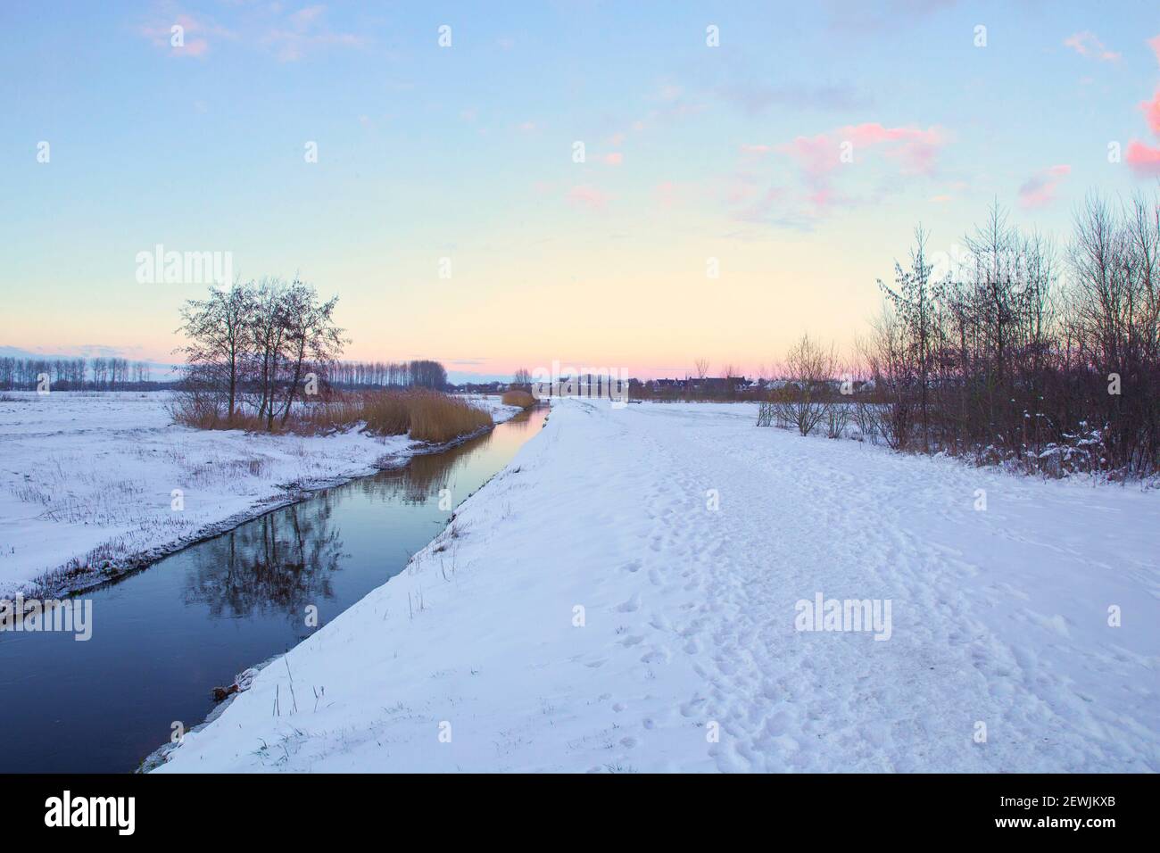 Winter landscape in The Netherlands with beautiful colored sunset sky ...