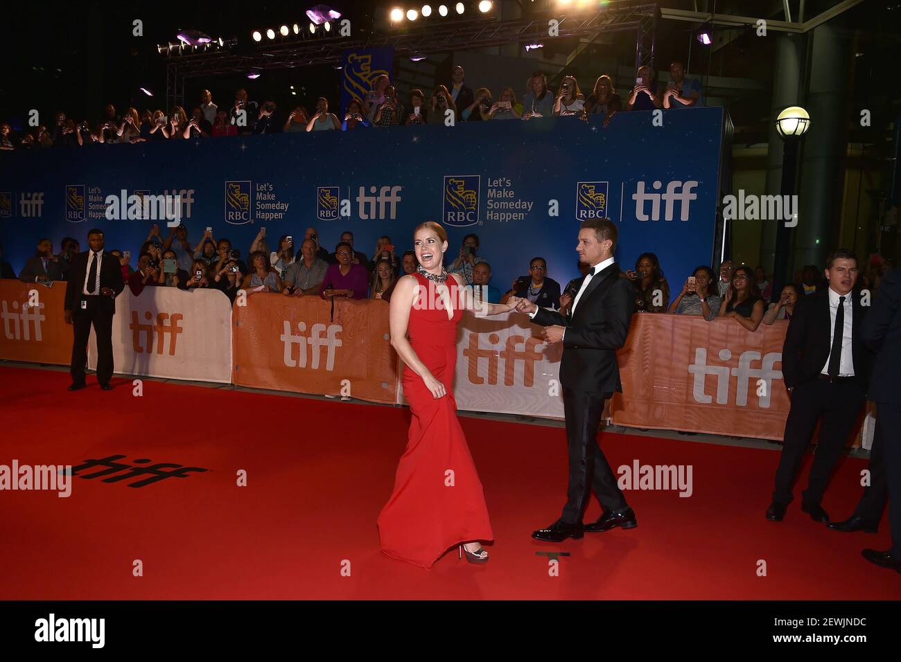 (L-R) Actors Amy Adams and Jeremy Renner take dance steps as they walk ...