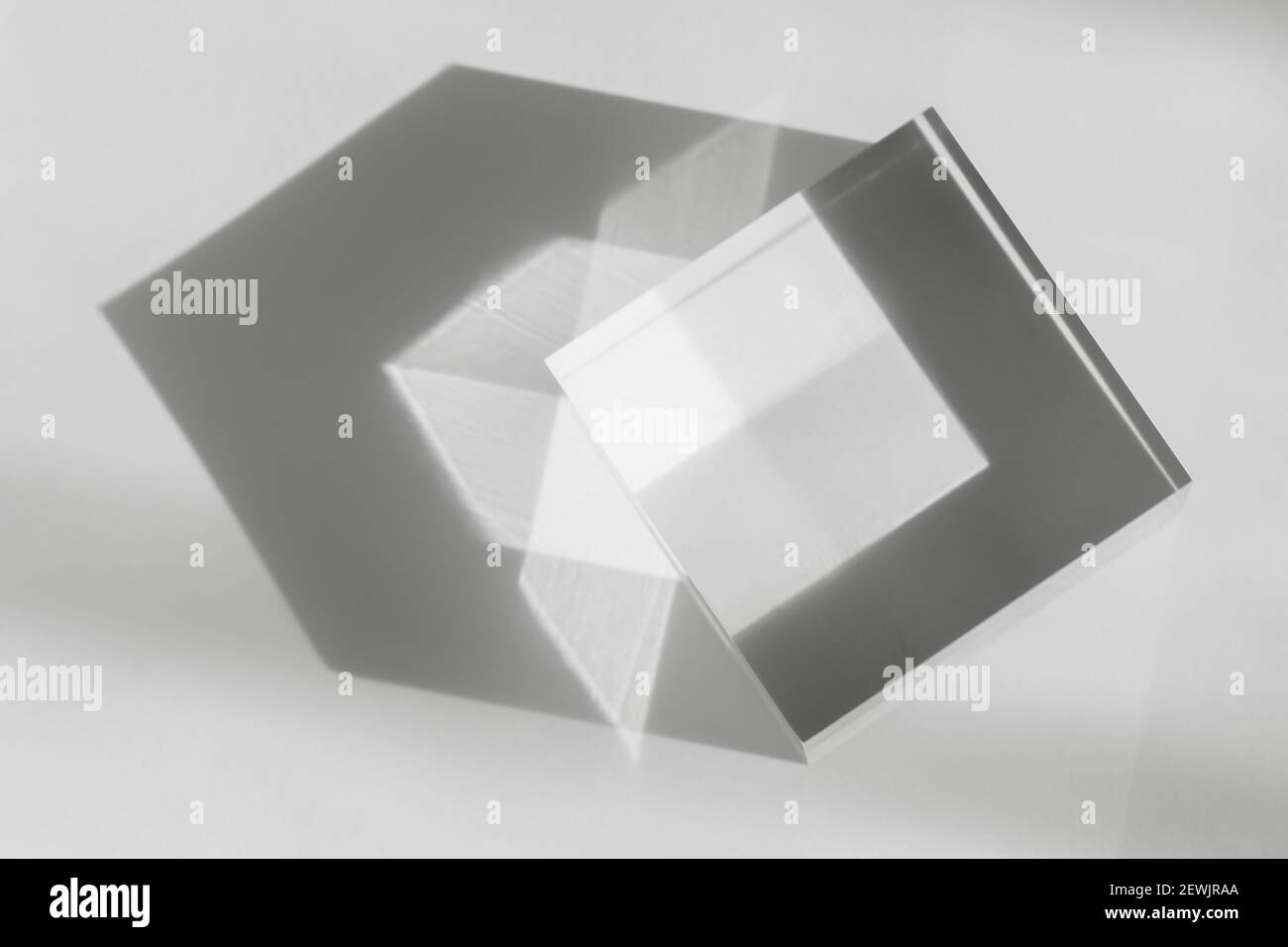 Glass transparent cube with sun reflection, light and shadow on white ...