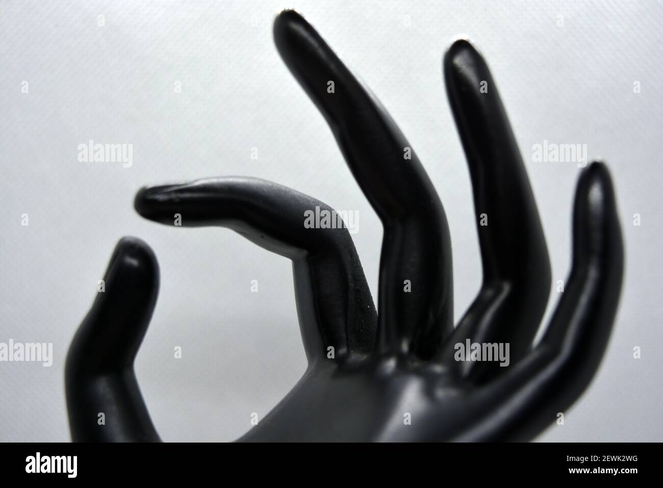 Black ceramic statue of female hand, female wrist located on a white ...