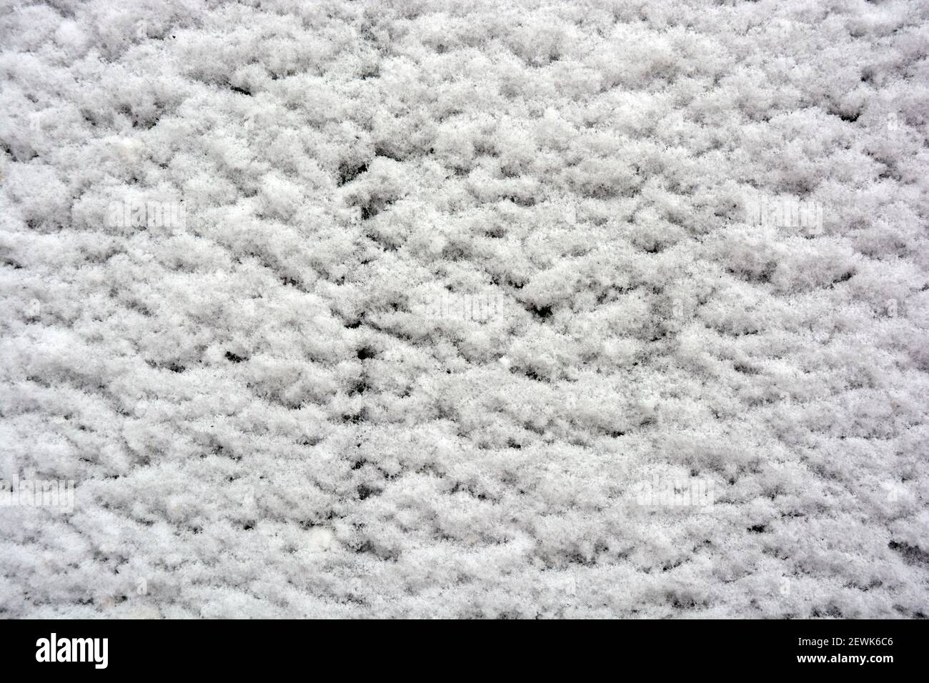 White soft unusual shaped snow is located on a brown metallic ...