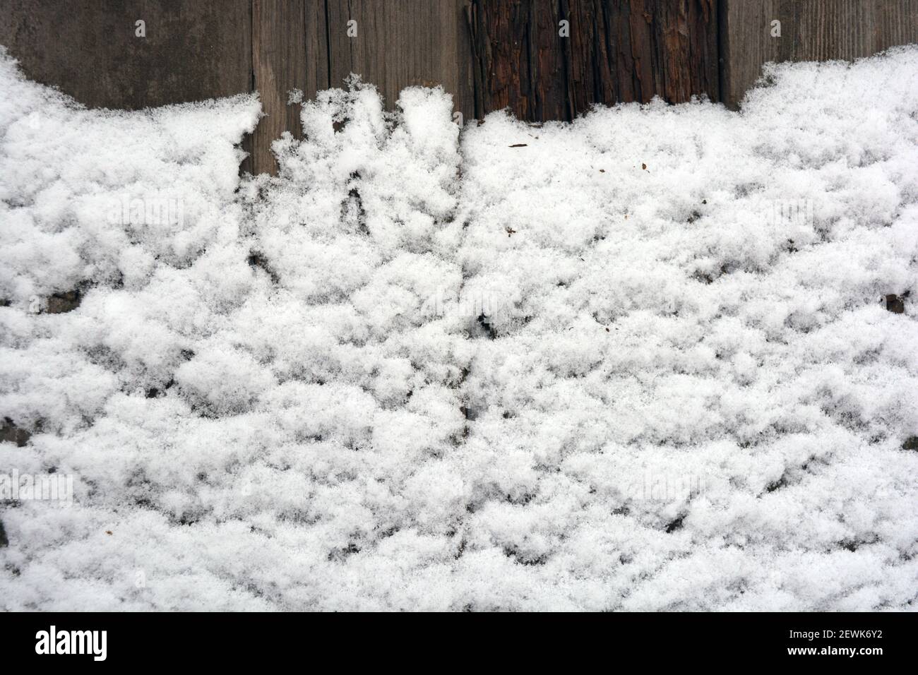 White soft unusual shaped snow is located on a brown metallic ...