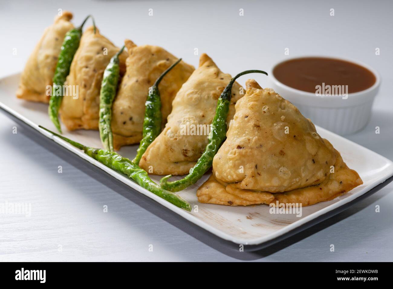 A crunchy delicious fried Samosa Indian snack with roasted chili ...