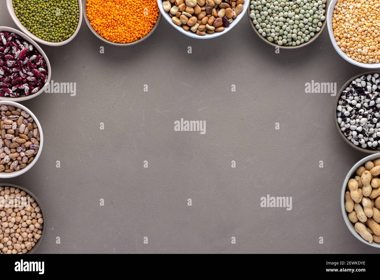 Different types of legumes in bowls, green and yellow peas, chickpeas ...