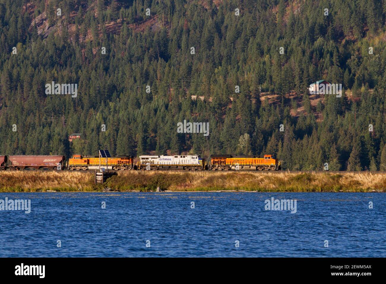 A Montana Rail Link train running BNSF locomotives by Lake Pend Oreille ...