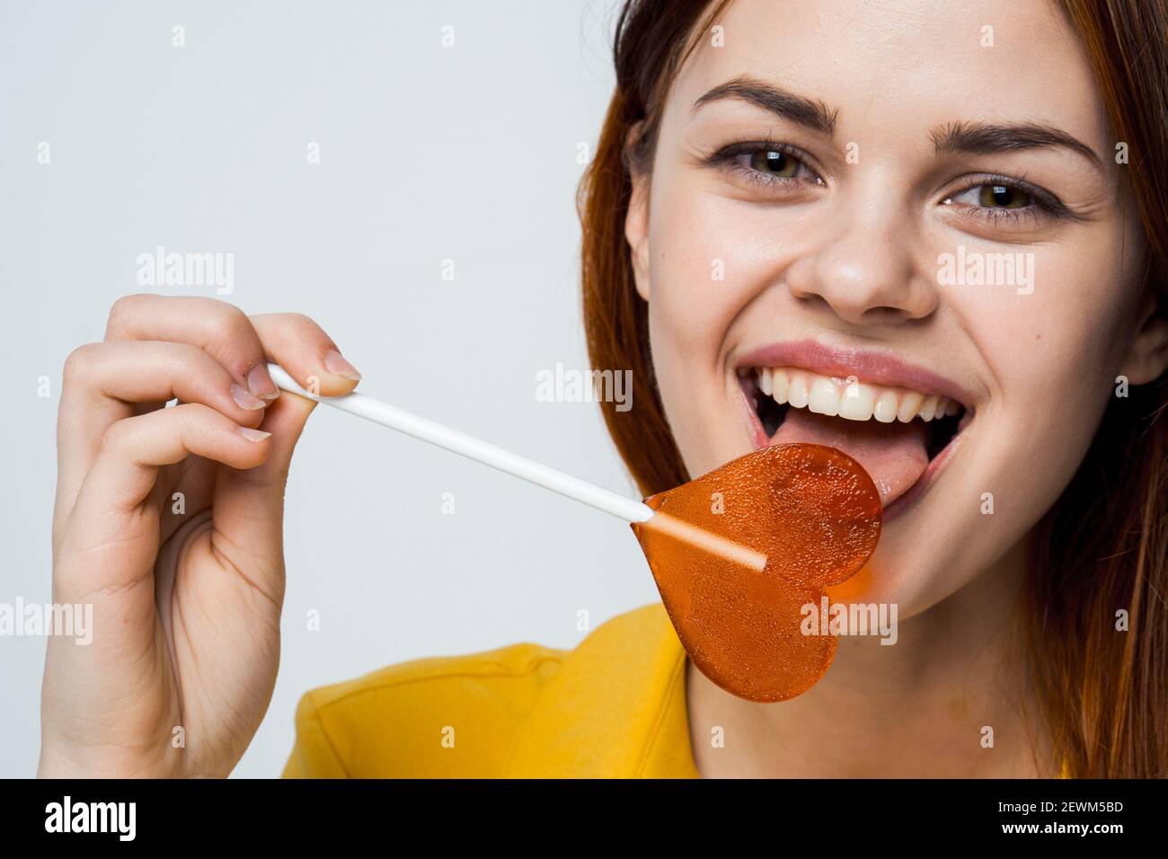 Cheerful attractive woman licking hi-res stock photography and images ...