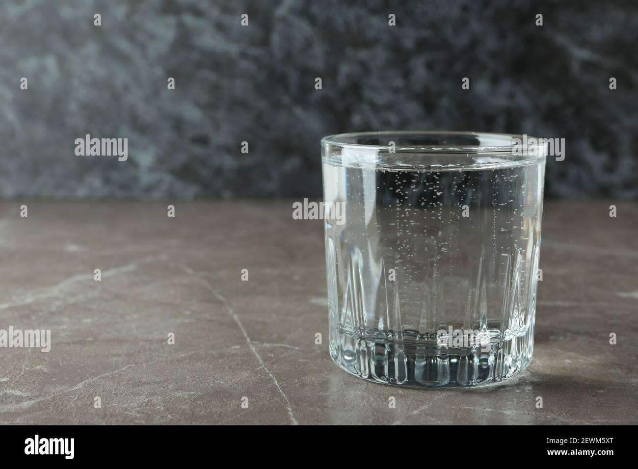 Glass of mineral water on gray table Stock Photo - Alamy