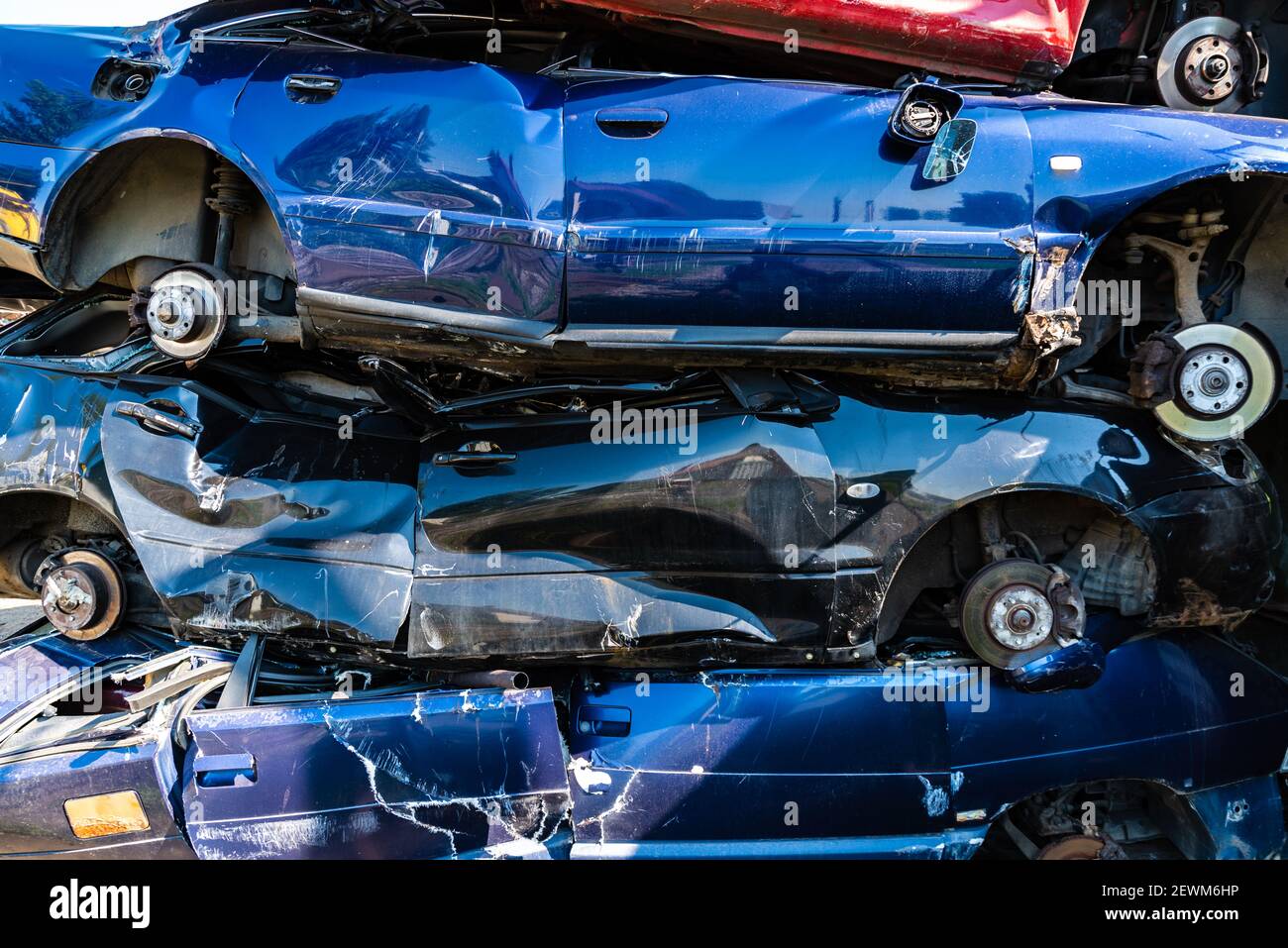 Stacked crushed cars going to be shredded in a recycling facility in ...