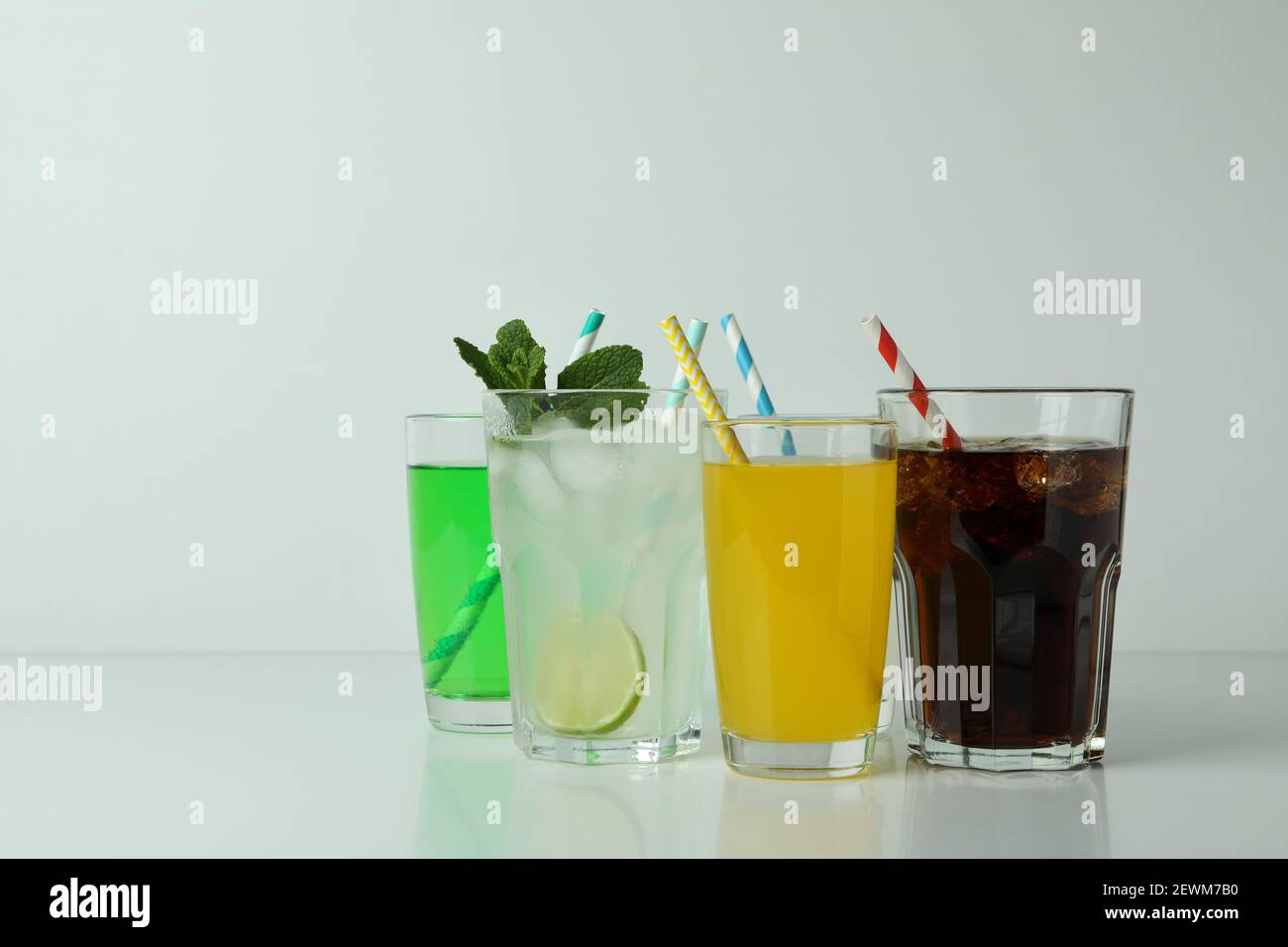 Glasses of different soda on white background Stock Photo - Alamy