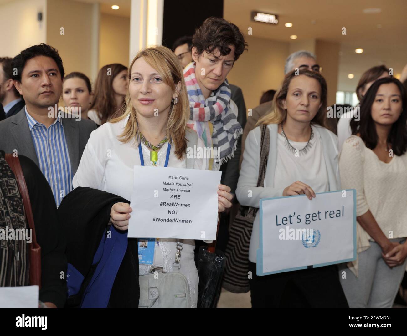 United Nations staff stand in a silent protest, during a U.N. meeting ...
