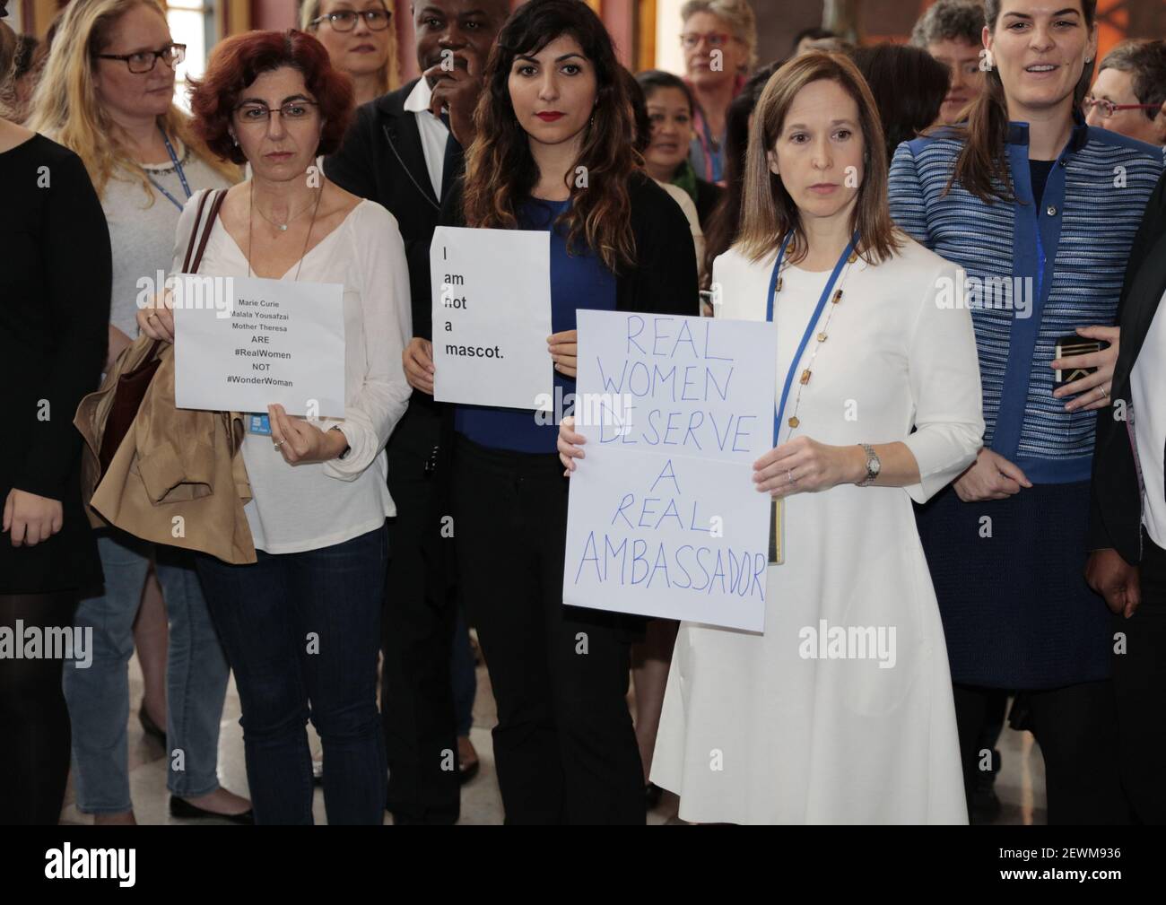 United Nations staff stand in a silent protest, during a U.N. meeting ...