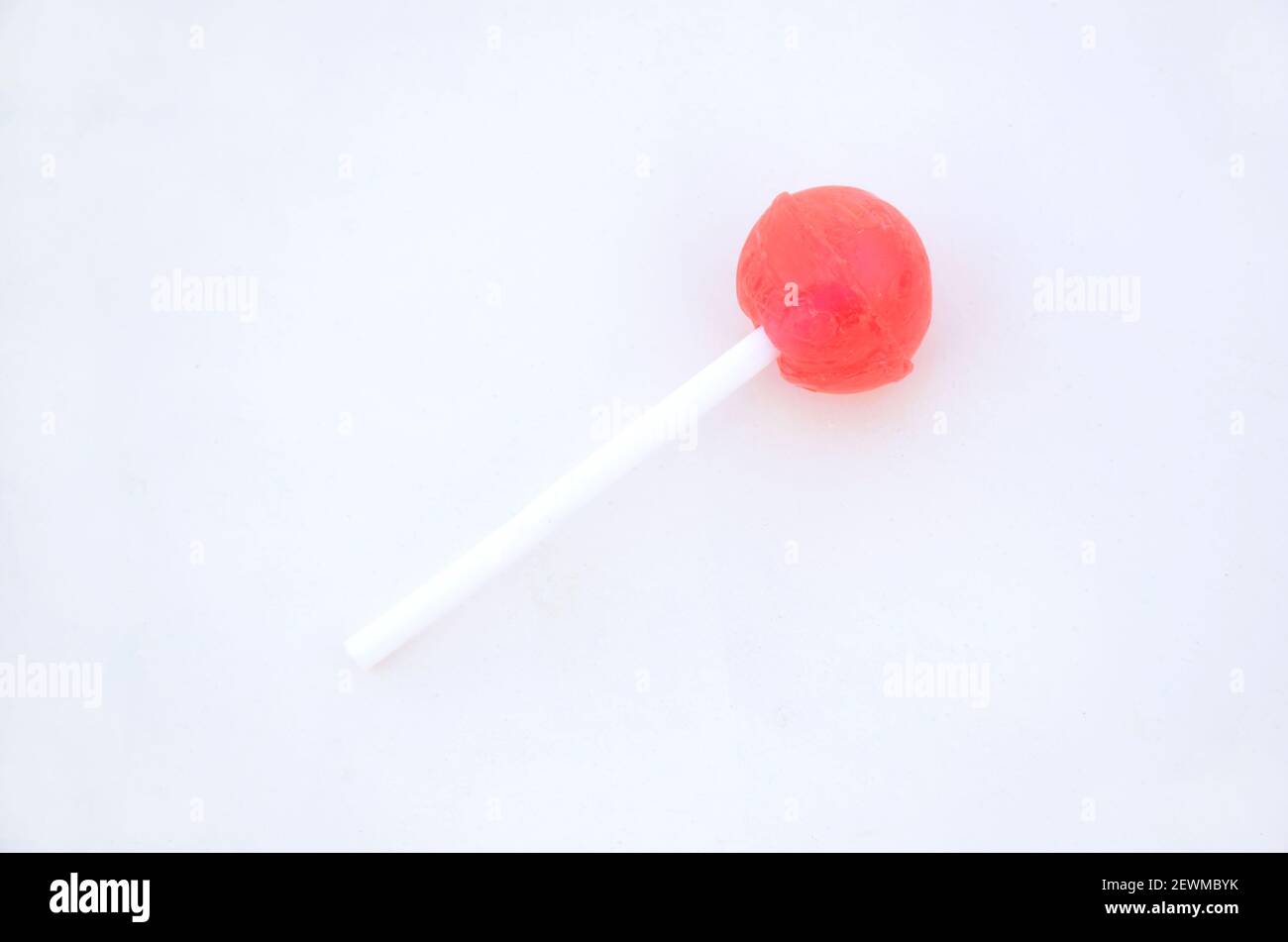 The sweet pink lollypop isolated on white background Stock Photo - Alamy