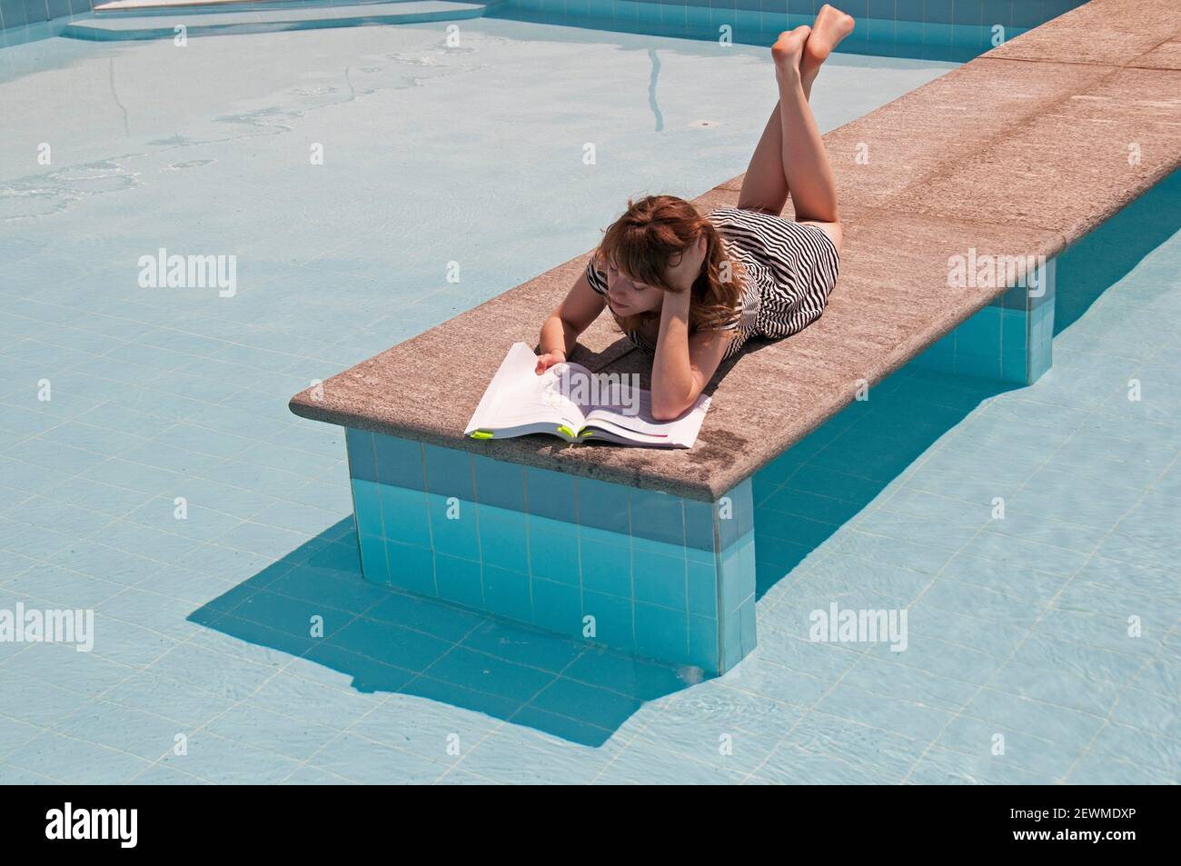 Woman laying poolside hi-res stock photography and images - Alamy