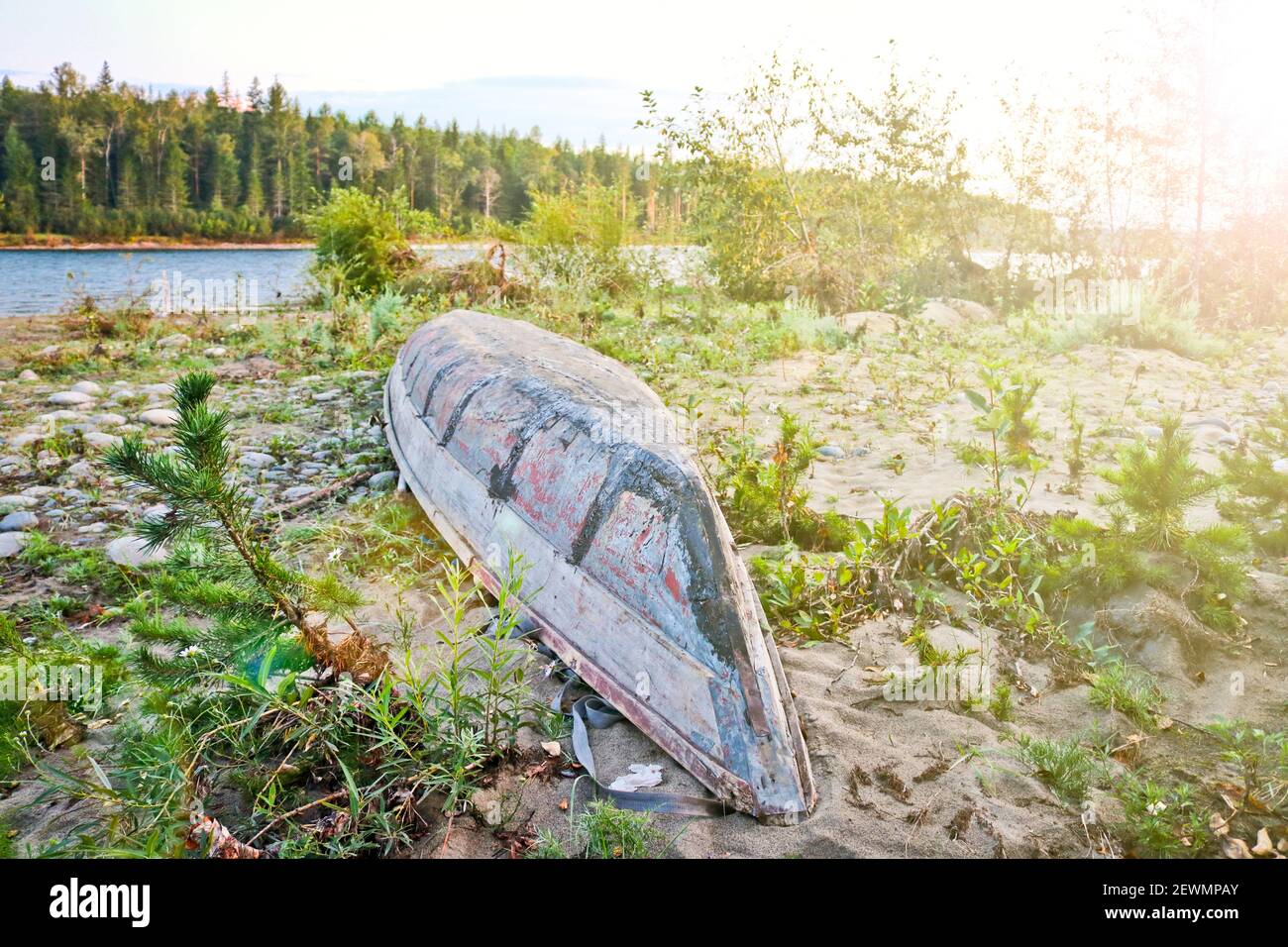 Old fishing rowboat on the sand on the river bank, Siberia, Russia ...