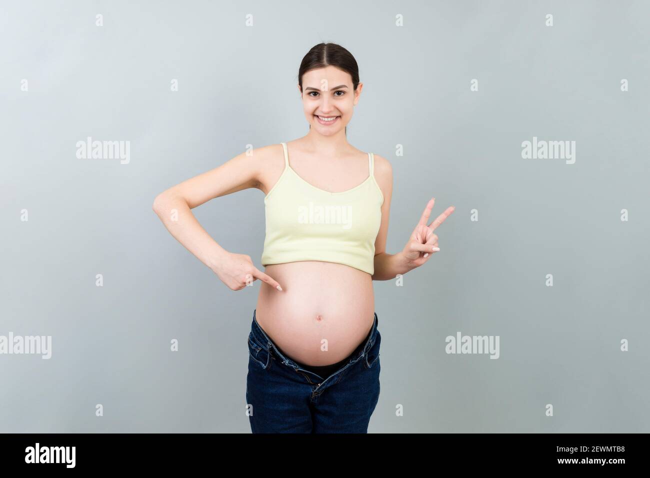 Young beautiful teenager girl pregnant expecting baby over isolated ...