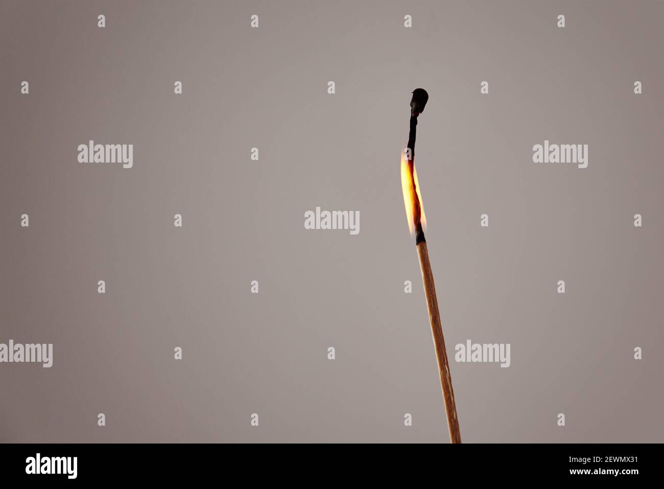Burning matchstick on dark background with copy space Stock Photo - Alamy