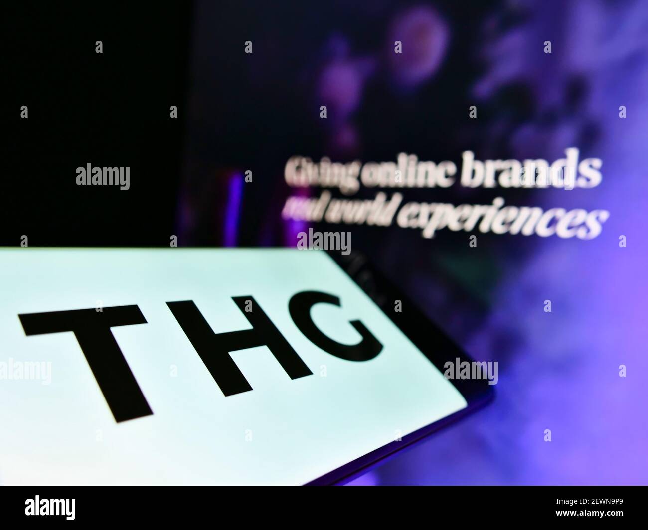 Cellphone with logo of British e-commerce company THG Holdings plc on ...