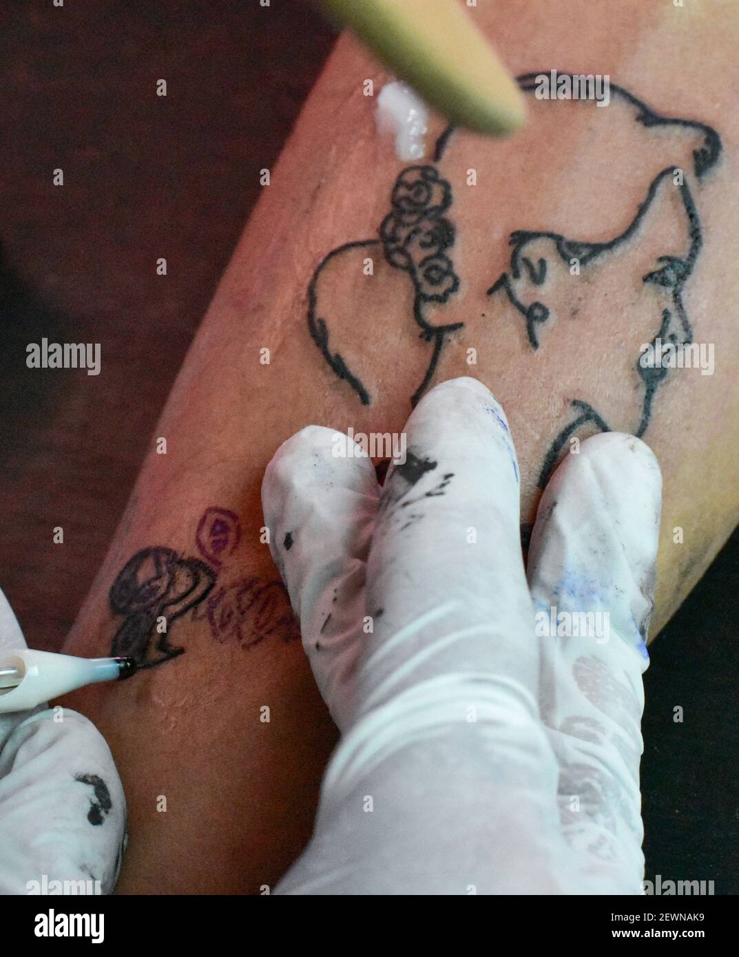 Myanmar, Nyaung Shwe,02 March 2021, : A tattoo artist works on a ...