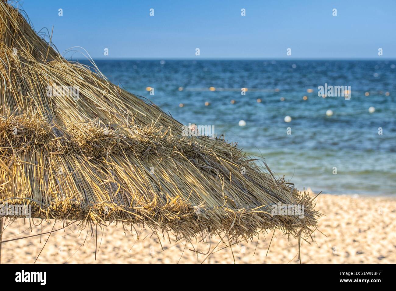 straw parasol on a beach Stock Photo - Alamy