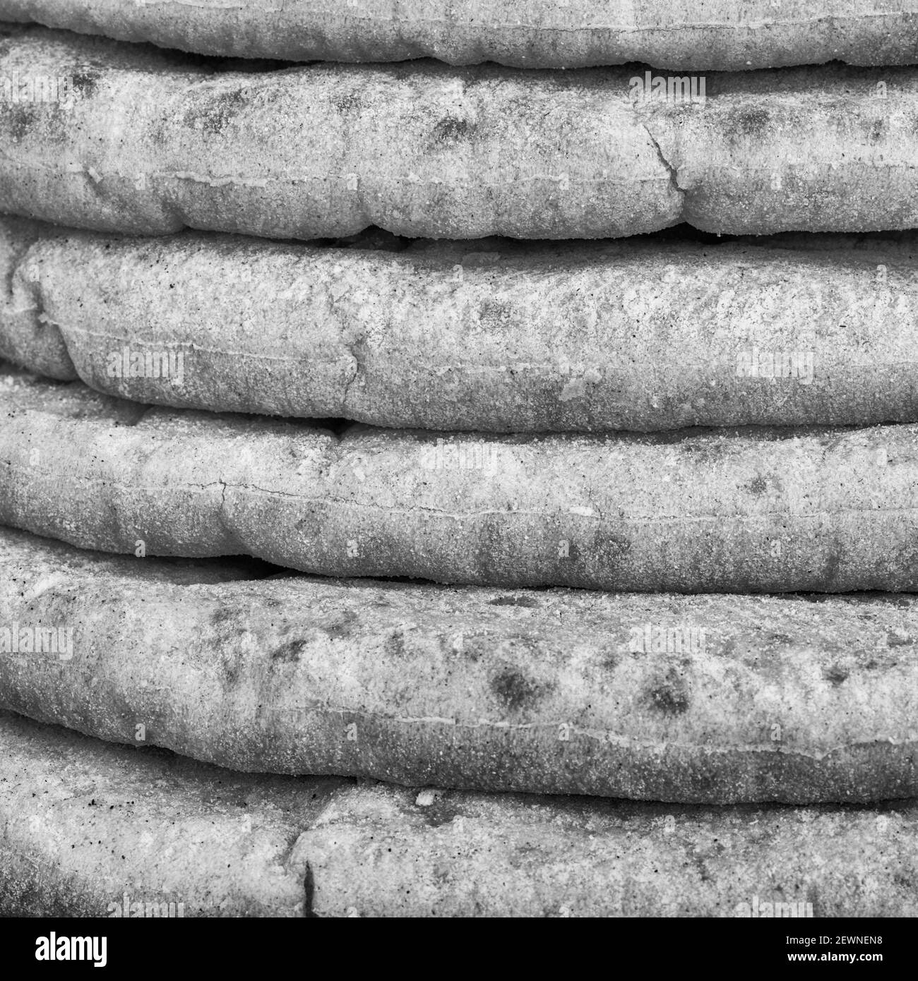 Gritty black and white abstract of stacked Pitta breads as used in ...