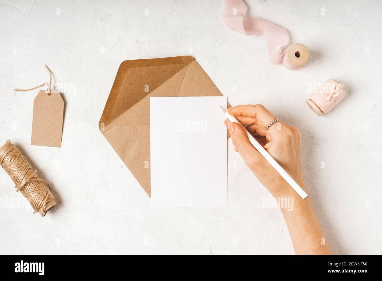 Blank white card with craft paper envelope in hands Stock Photo - Alamy