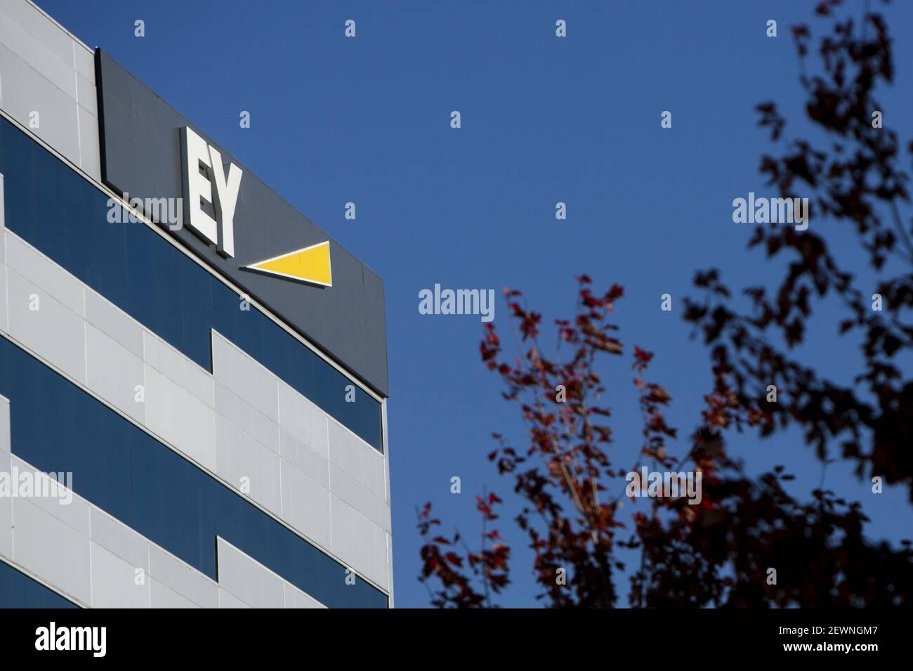 A logo sign outside of a facility occupied by EY (Ernst & Young) in ...