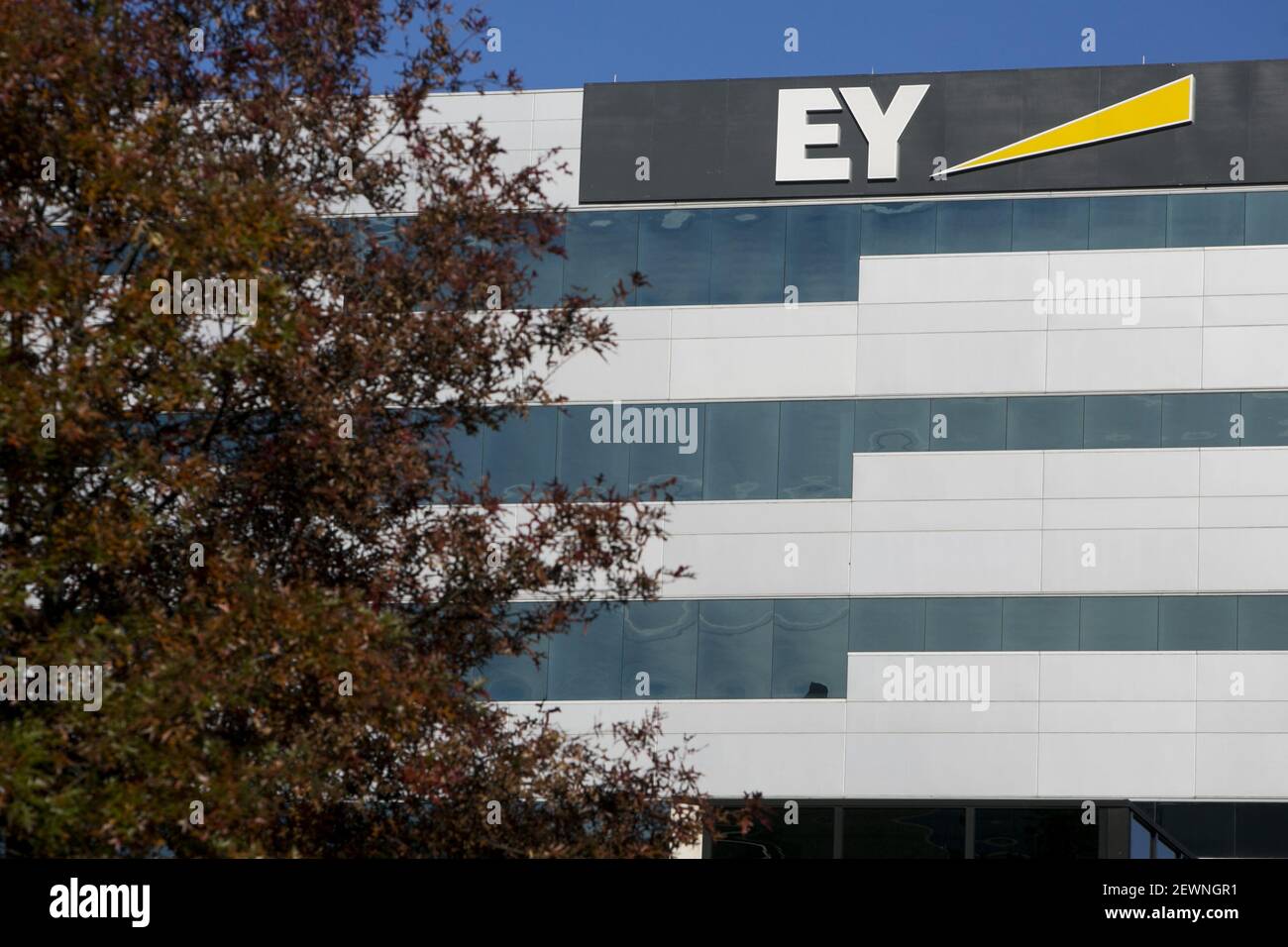 A logo sign outside of a facility occupied by EY (Ernst & Young) in ...
