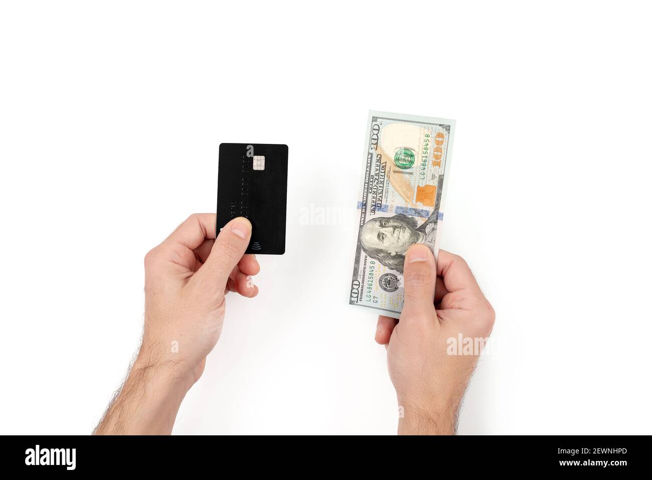 Men's hands holding credit or debit card and one hundred banknote ...