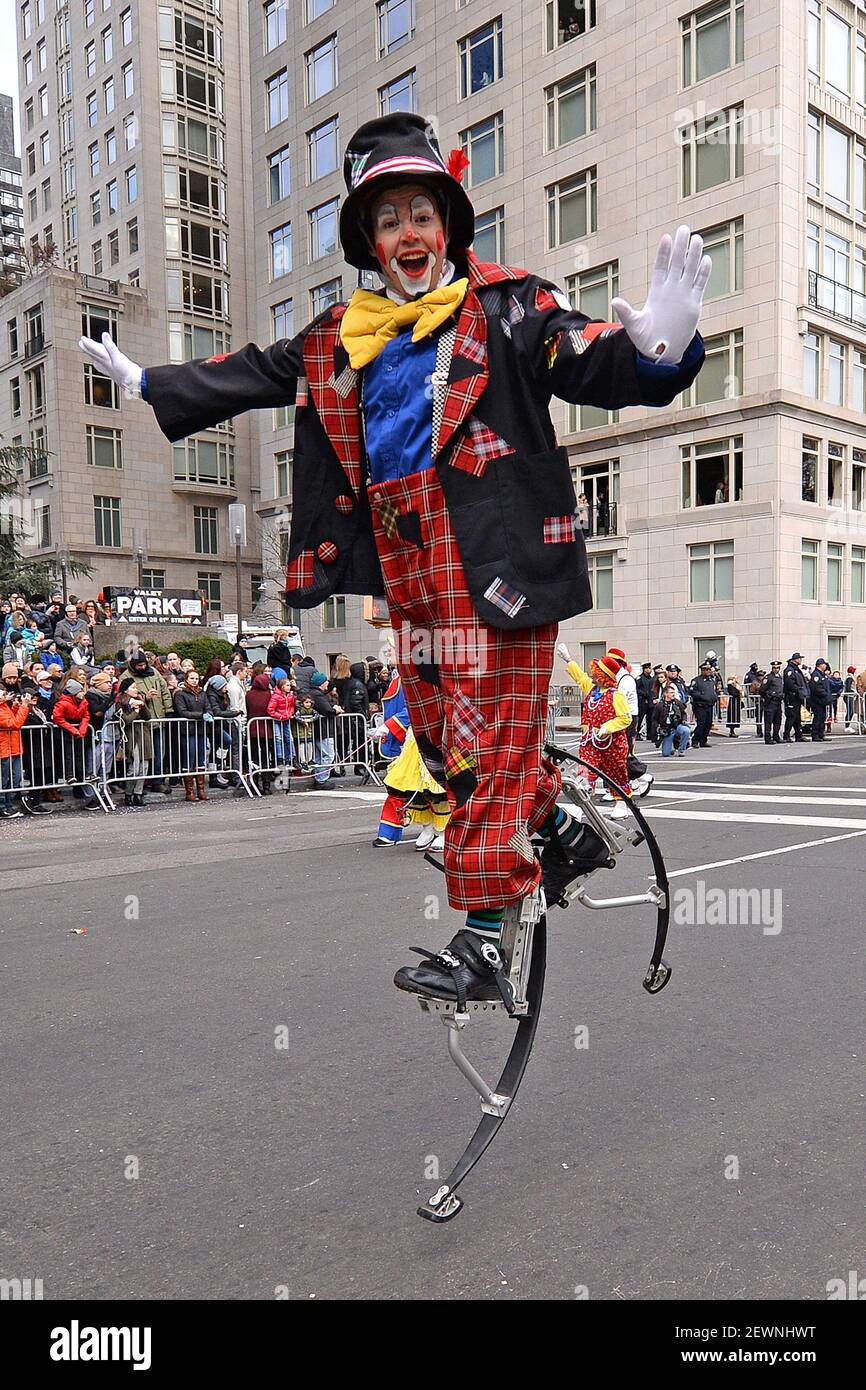 A clown wearing spring-loaded legs makes his way down Central Park West ...
