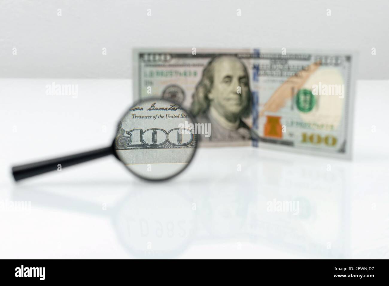 Hundred dollar bill and magnifying glass on white background. Zoom ...