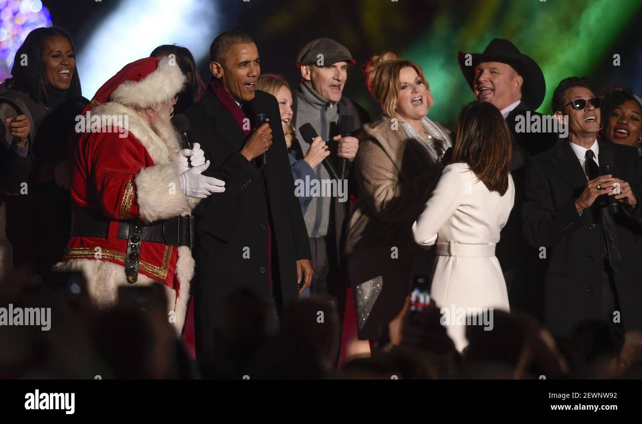 President Barack Obama sings alongside (L-R) Michelle Obama, Santa ...