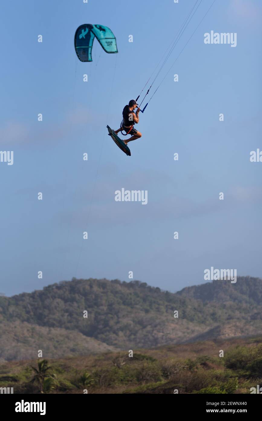 kite-surfing man jumping at kitesurf. kitesurfer athlete performing ...