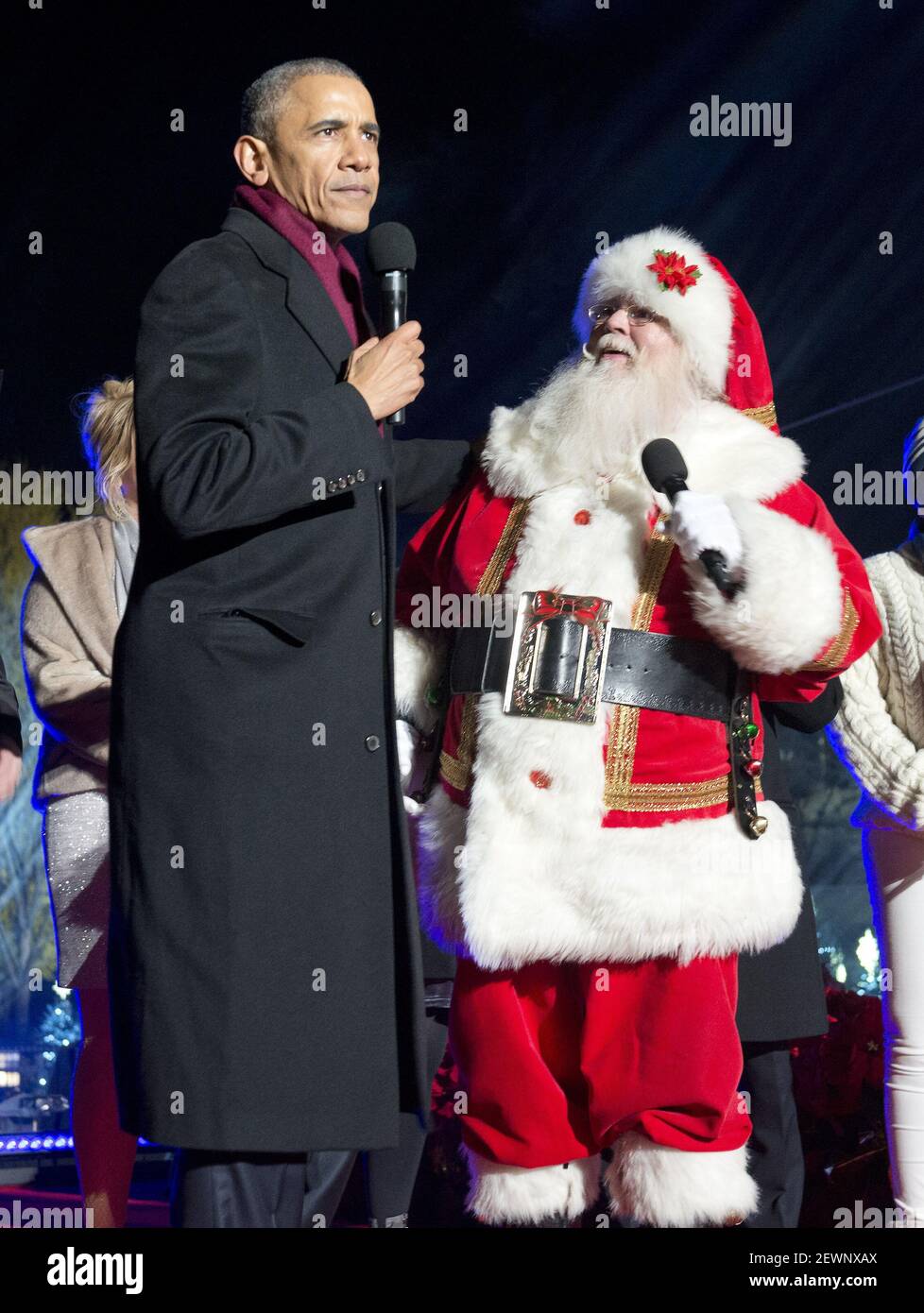 United States President Barack Obama on stage with Santa Claus to sing ...