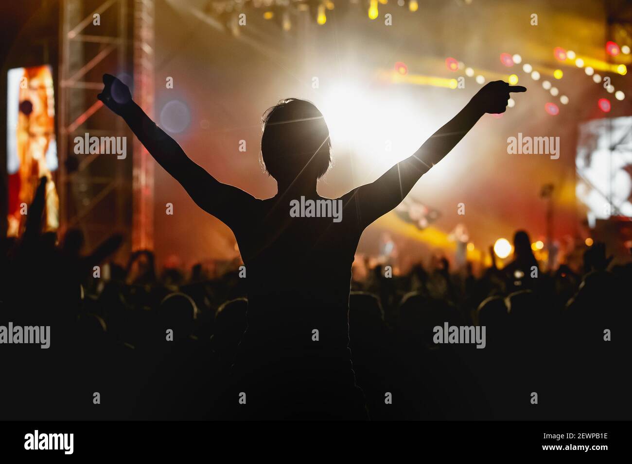 Silhouette of girl with raised hands on music concert Stock Photo - Alamy