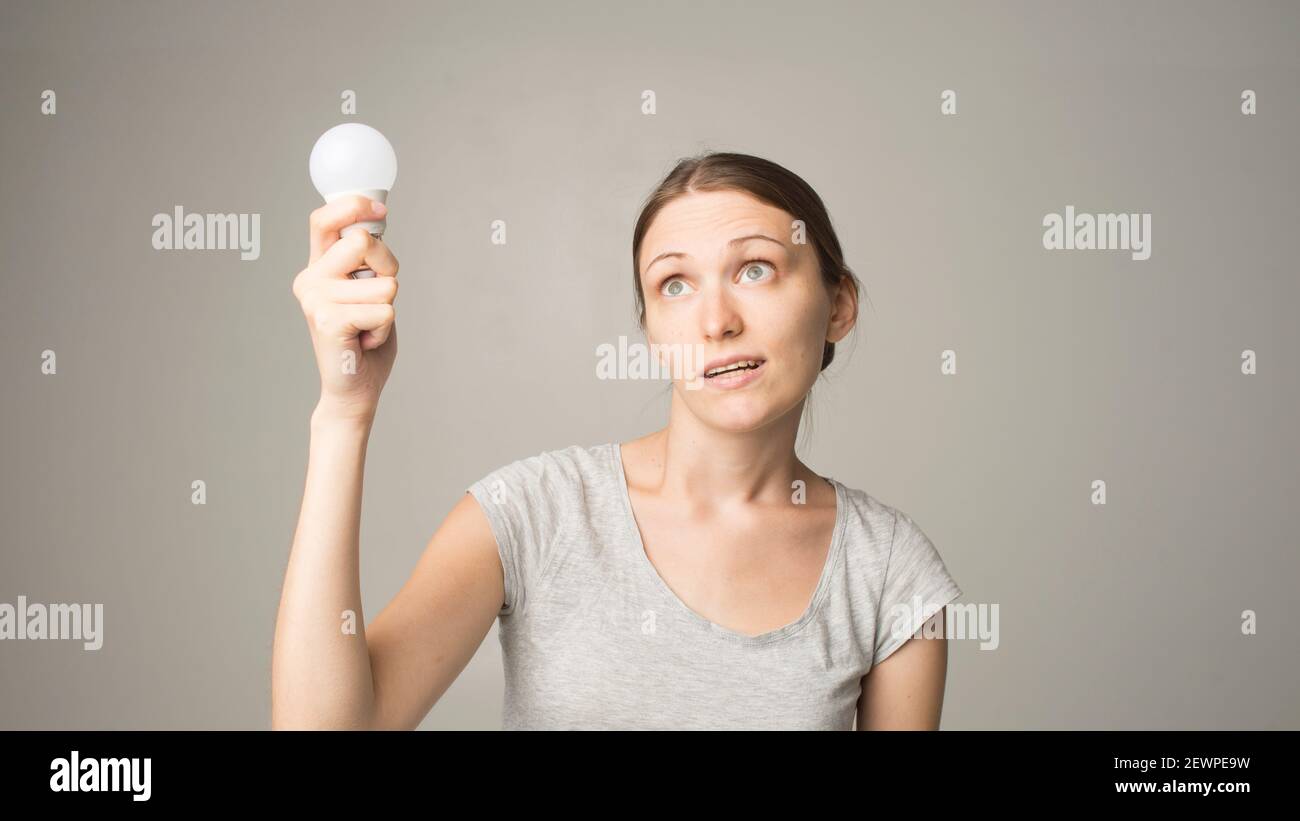 young pretty woman with black hair with a light bulb Stock Photo - Alamy