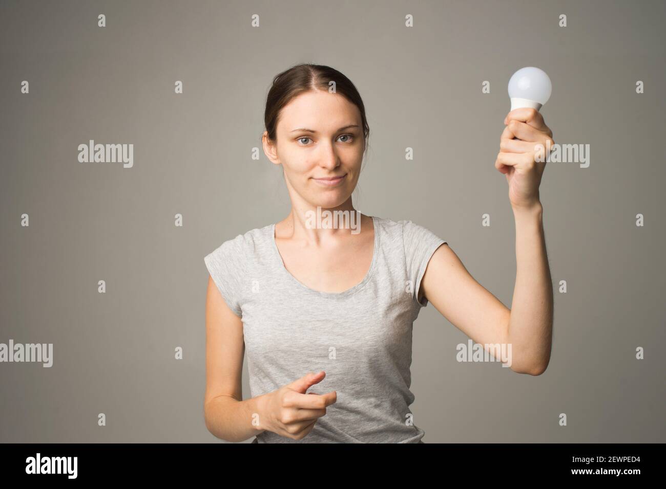 young pretty woman with black hair with a light bulb Stock Photo - Alamy