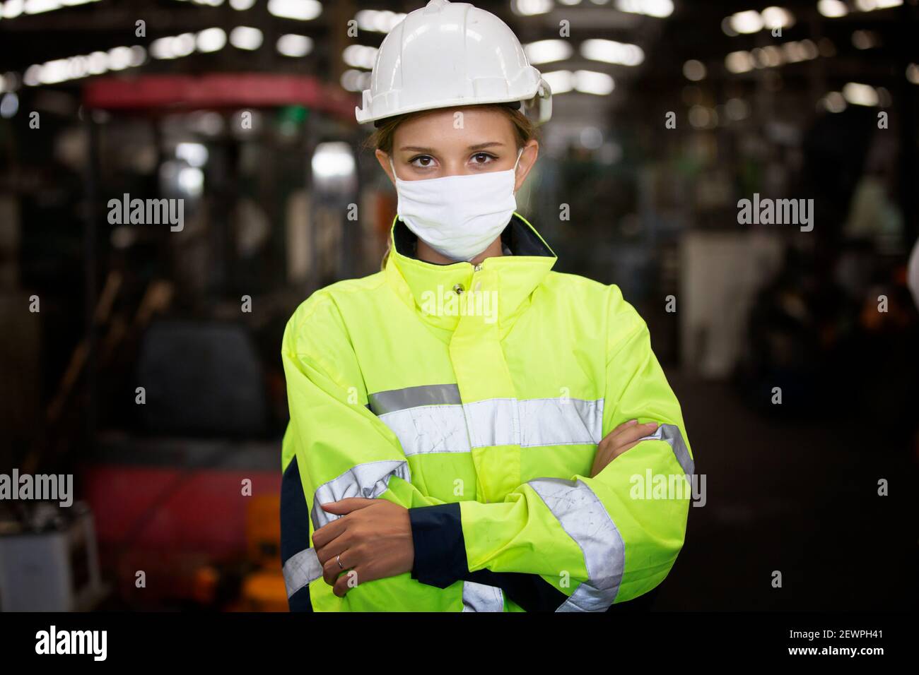 Workers wear protective face masks for safety in machine industrial ...