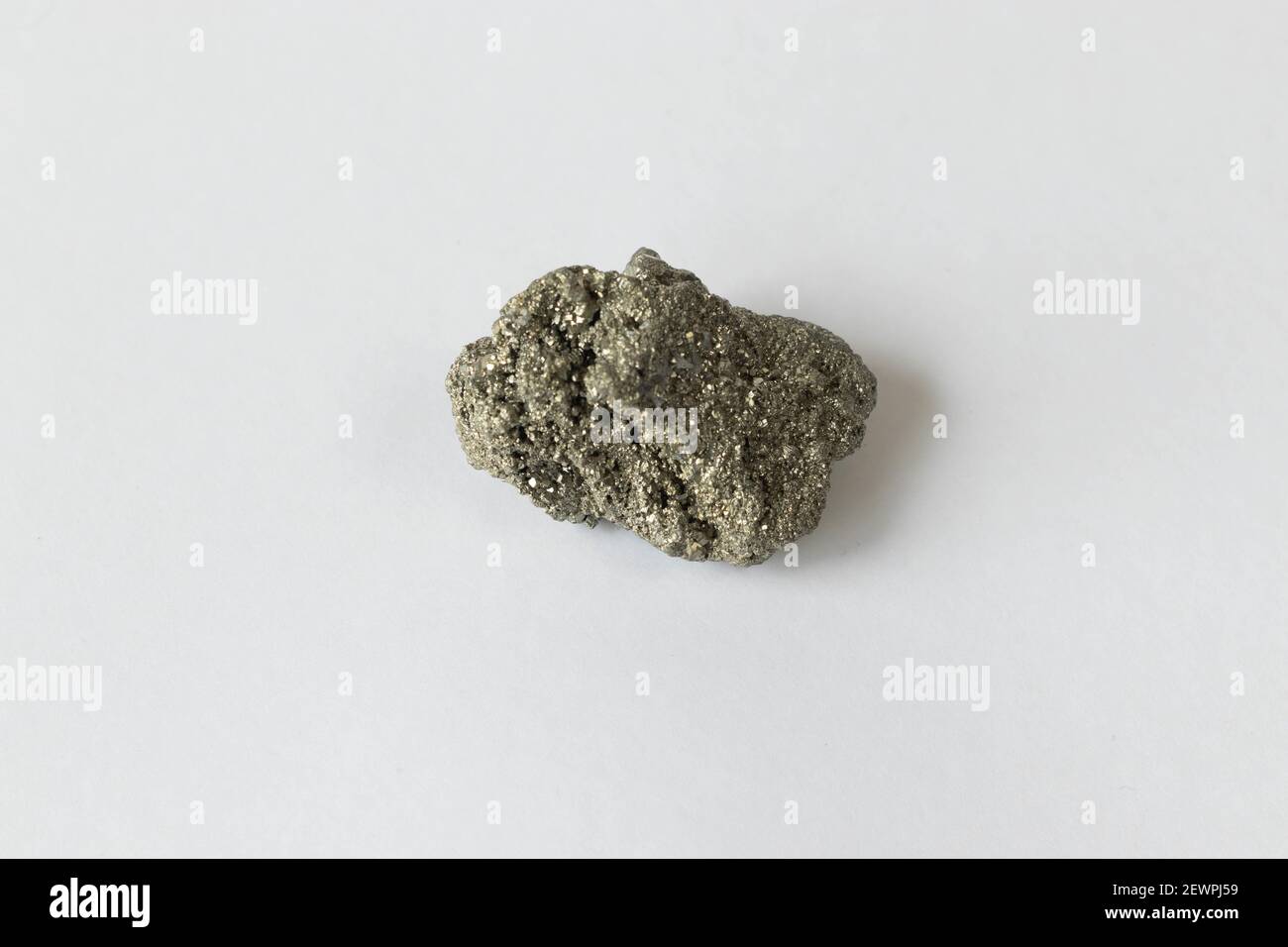 A pyrite stone isolated on a white background Stock Photo - Alamy