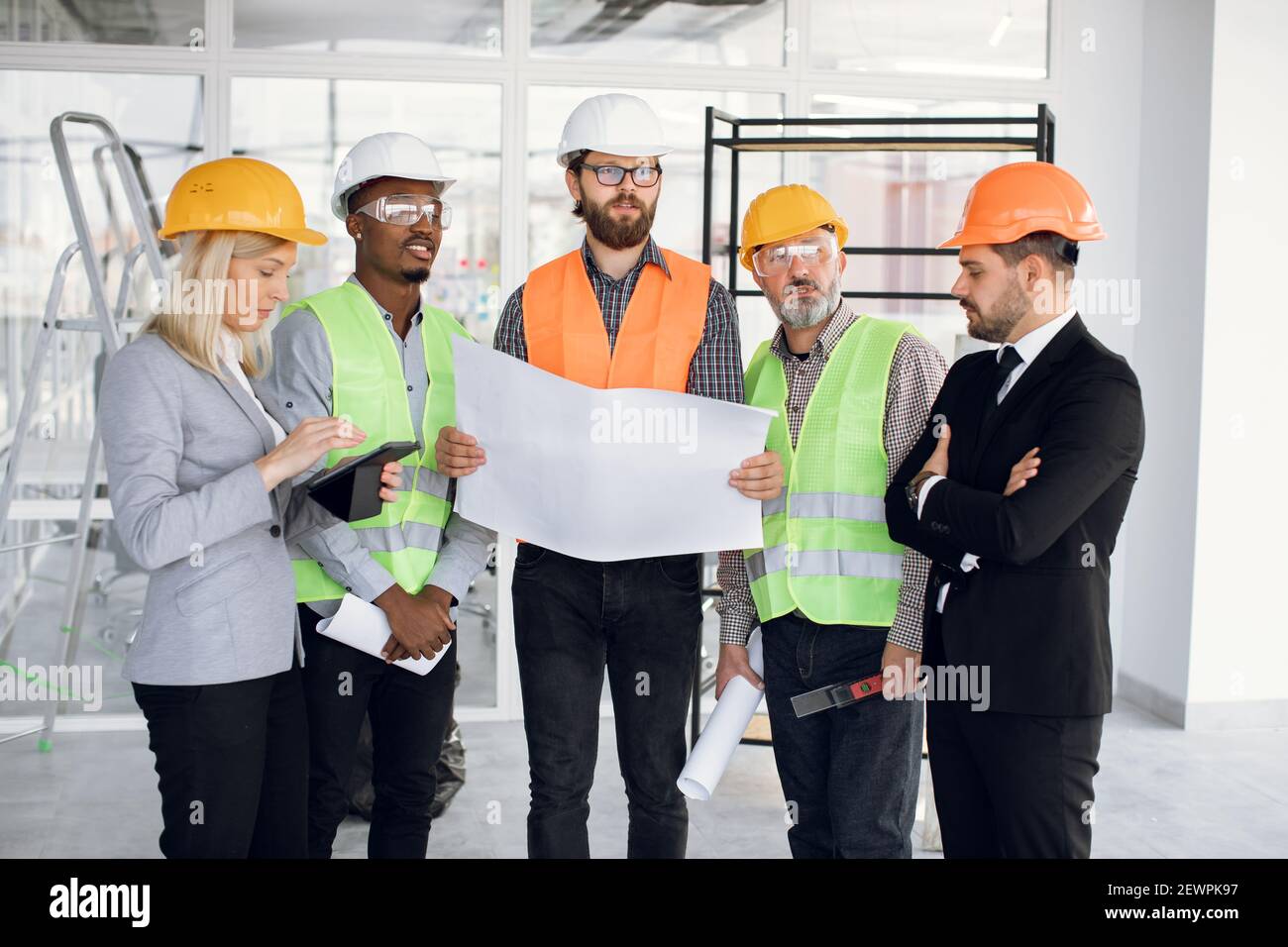 Five diverse people controlling process of construction Stock Photo - Alamy
