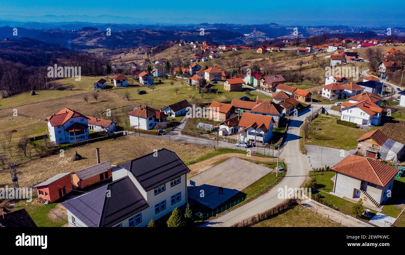 An aerial view of residential houses on a mountain in background of the ...