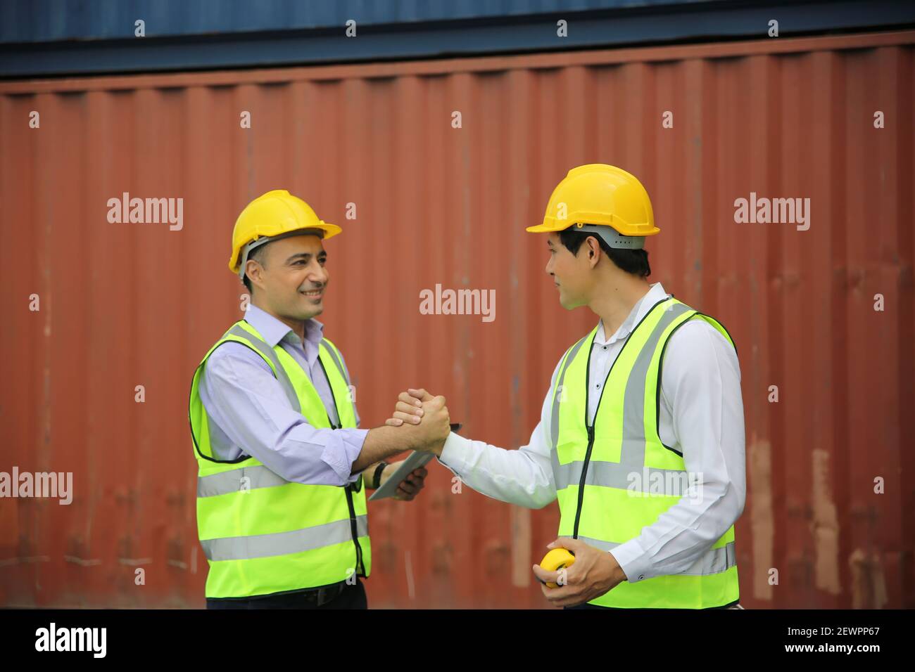 Logistics engineer control at the port, loading containers for trucks ...