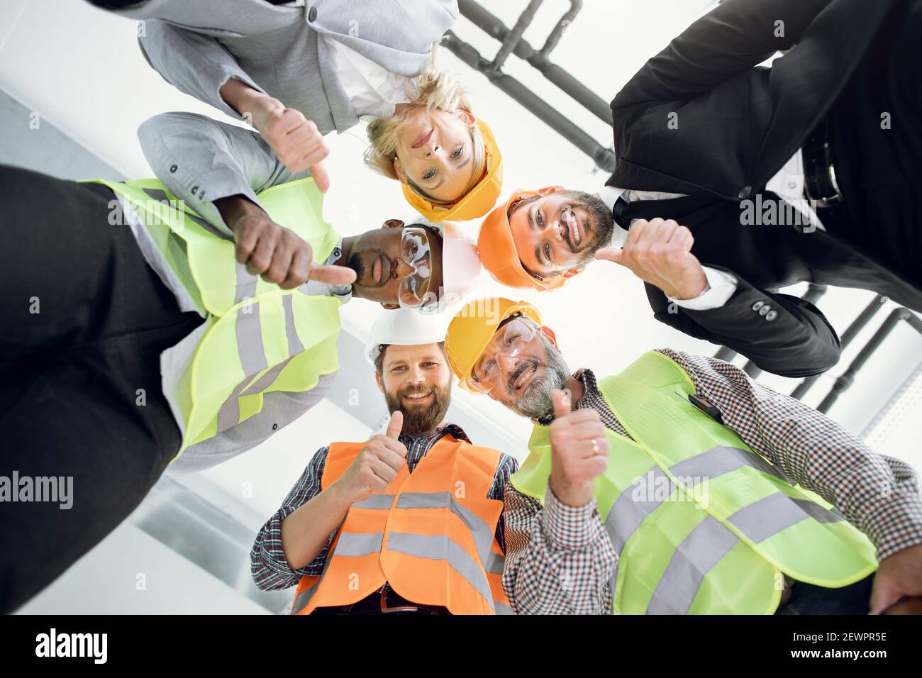 Multicultural construction team in protective helmet at work Stock ...