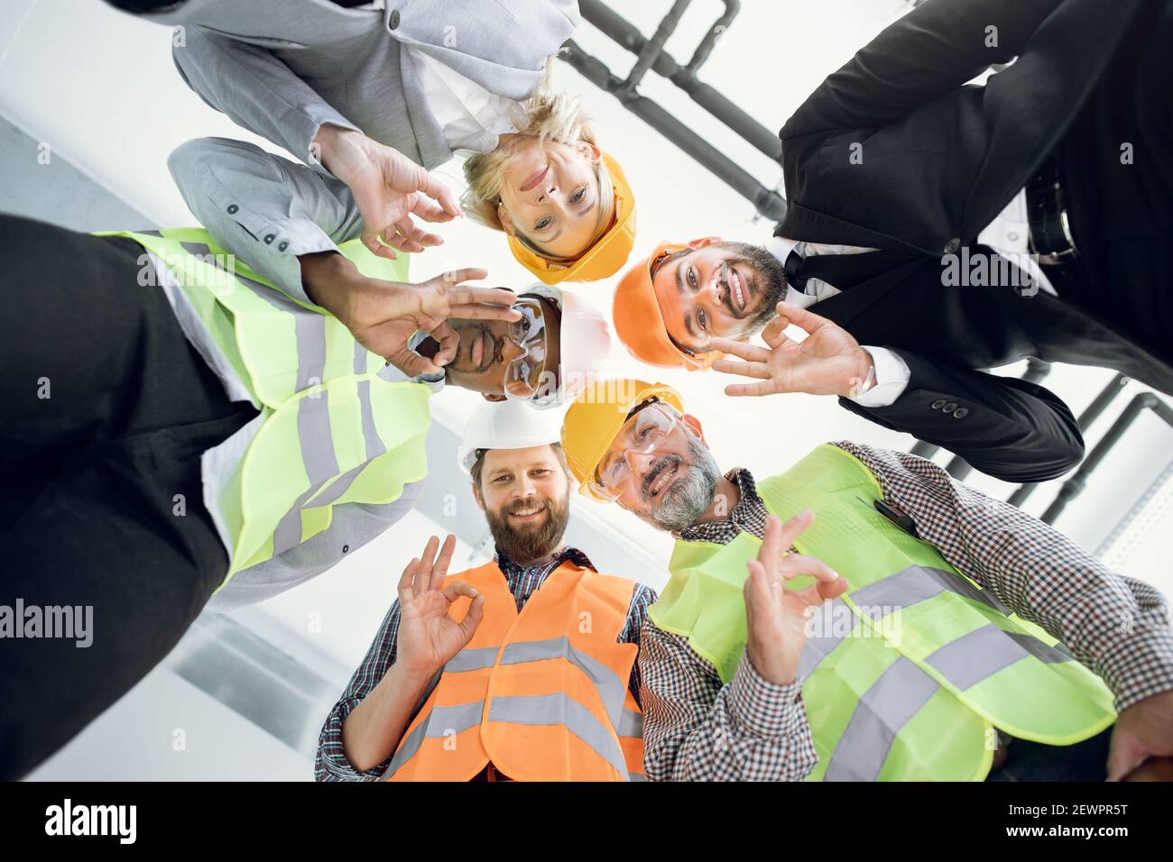 Multicultural construction team in protective helmet at work Stock ...