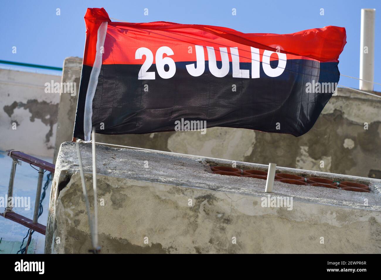 The 26 July flag seen on one of the buildings, a street scene from ...