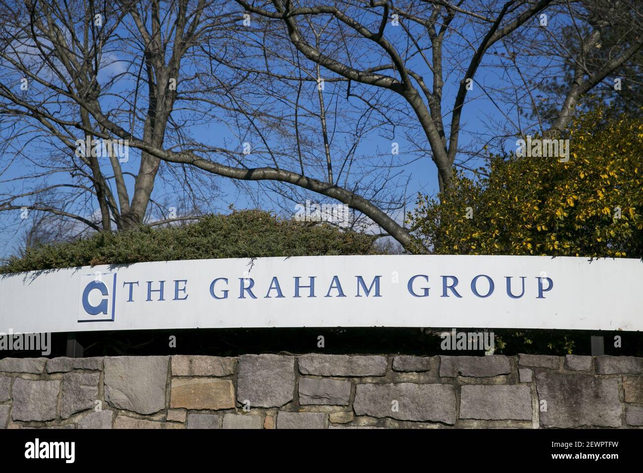 A logo sign outside of a facility occupied by The Graham Group in ...