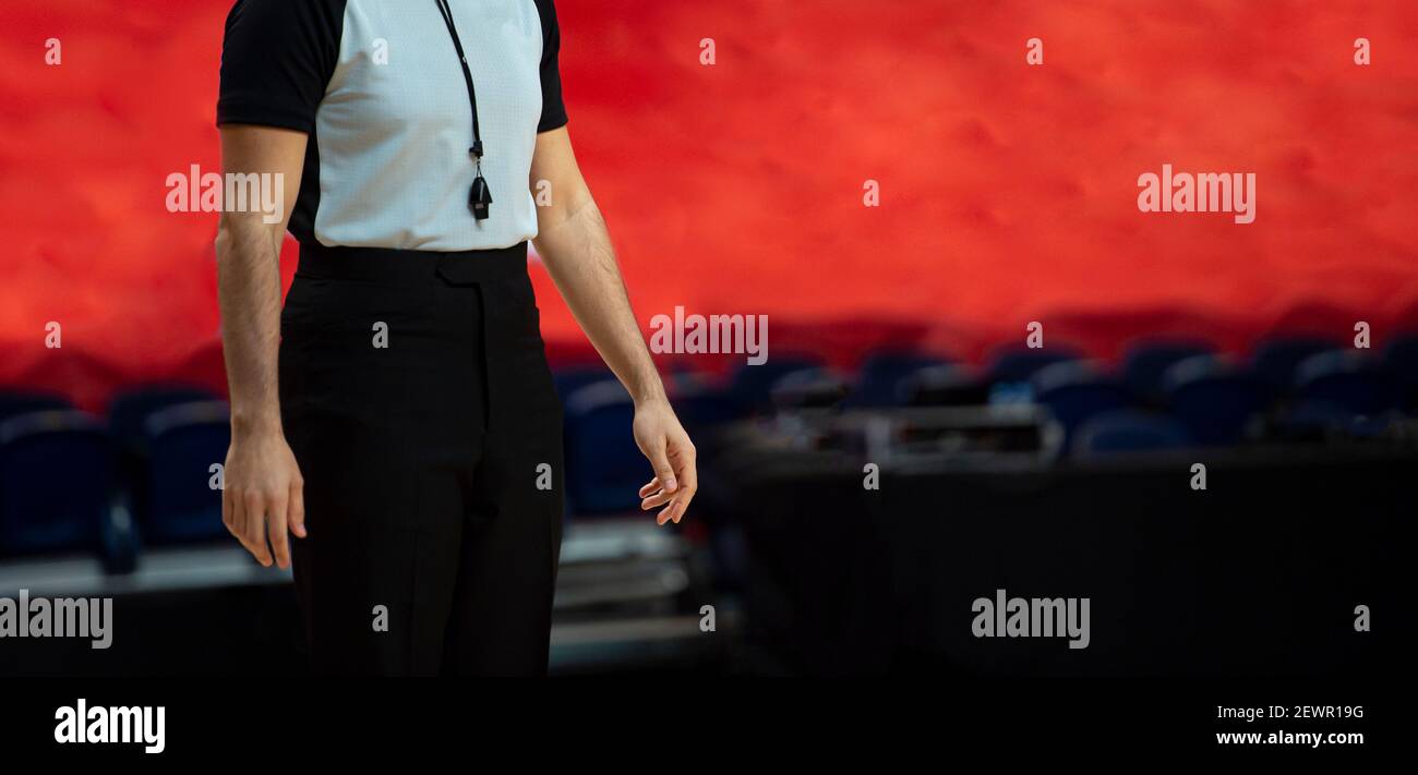 Basketball referee with whistle on red background Stock Photo - Alamy