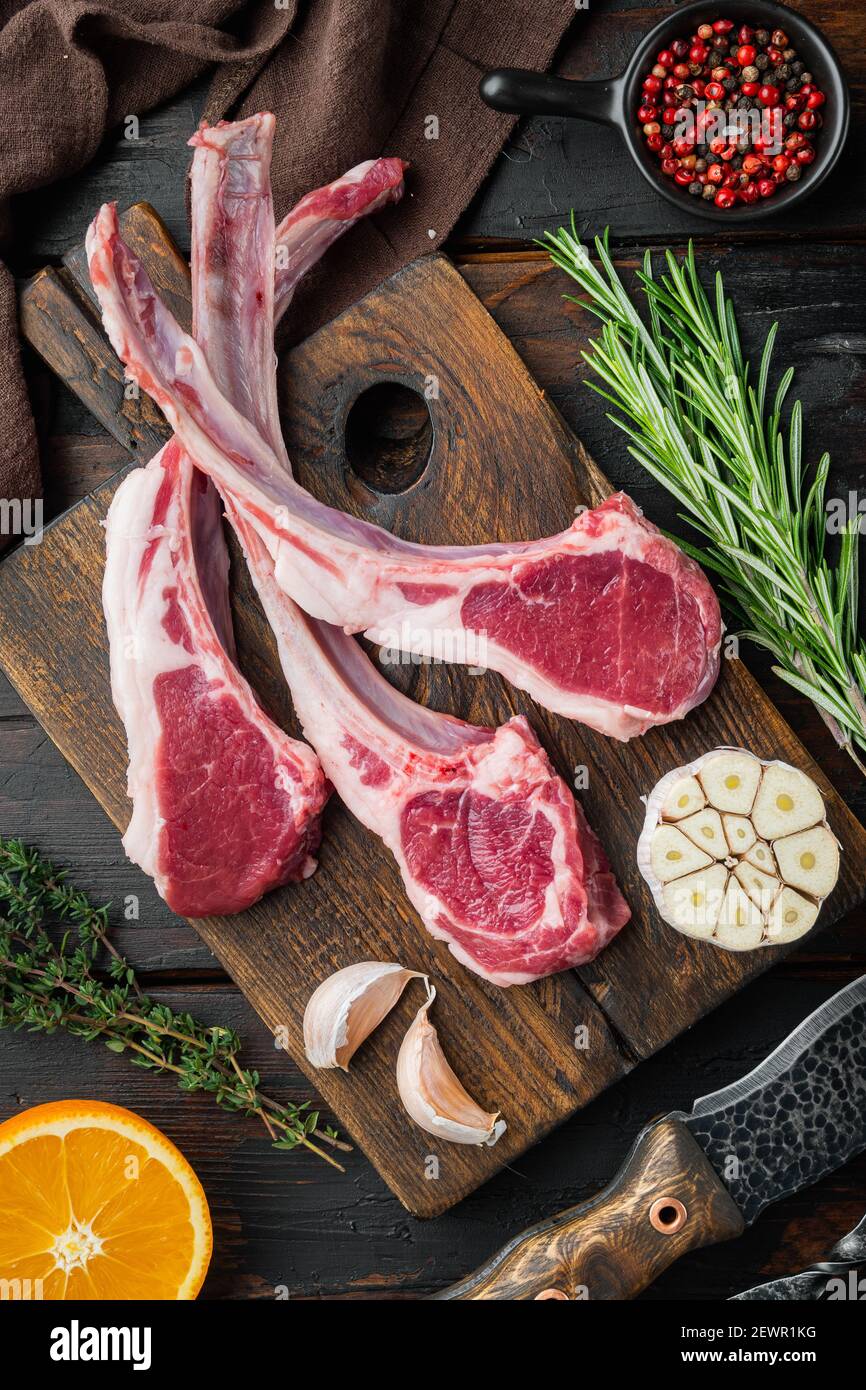 Raw Lamb Filets on bone set, with ingredients carrot orange, herbs, on ...