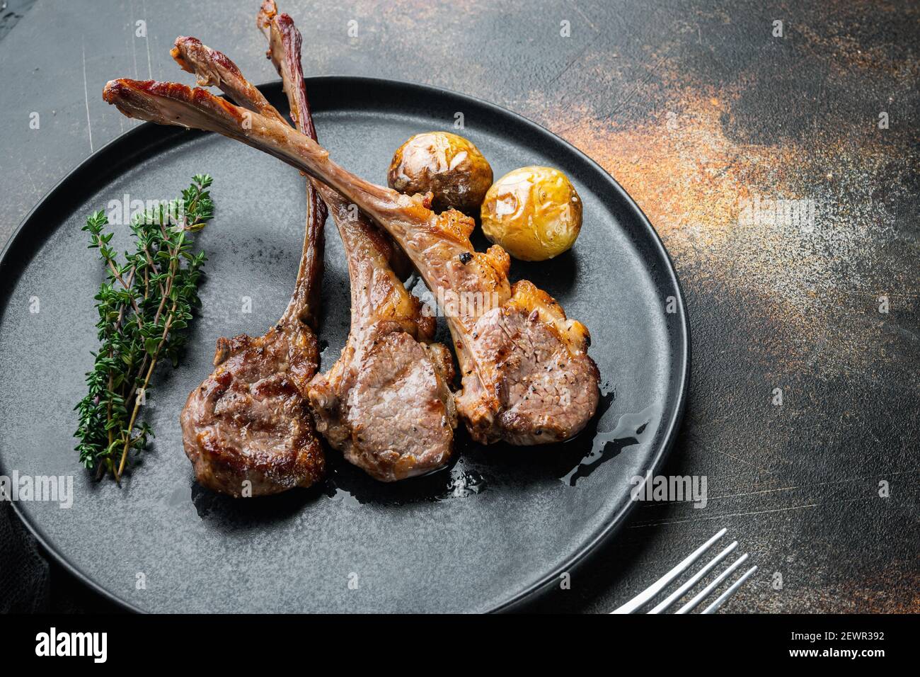 Homemade Cooked Lamb Chops with garlic and Carrots set, on plate, on ...