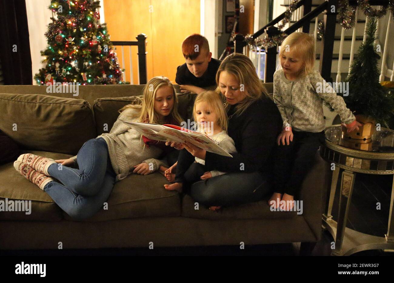 Kelly Reif reads to her daughters Florence, Colette, Aislynn and son C ...