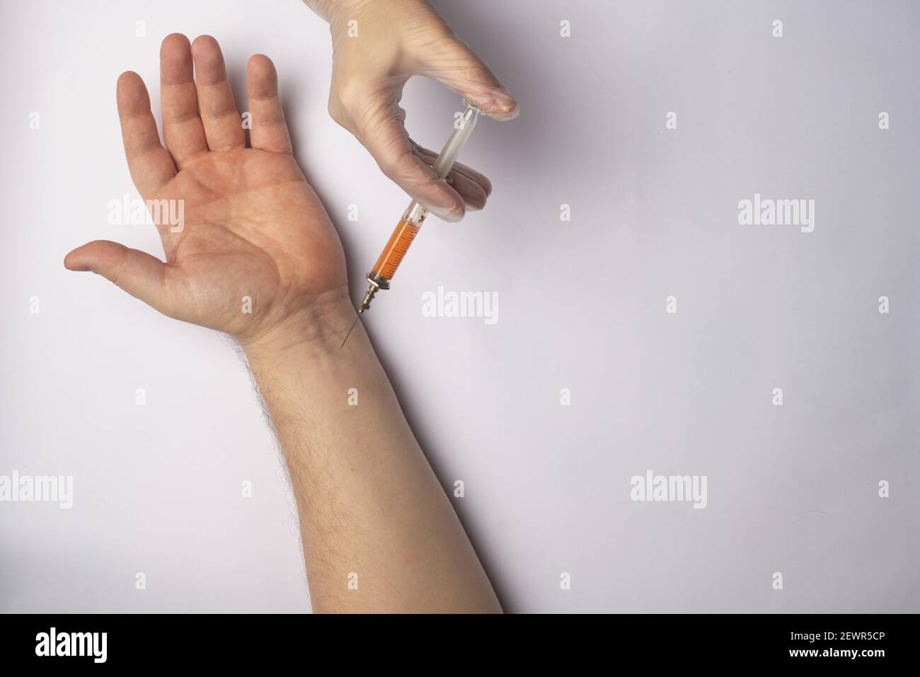 The doctor makes an injection in the hand of a person Stock Photo - Alamy